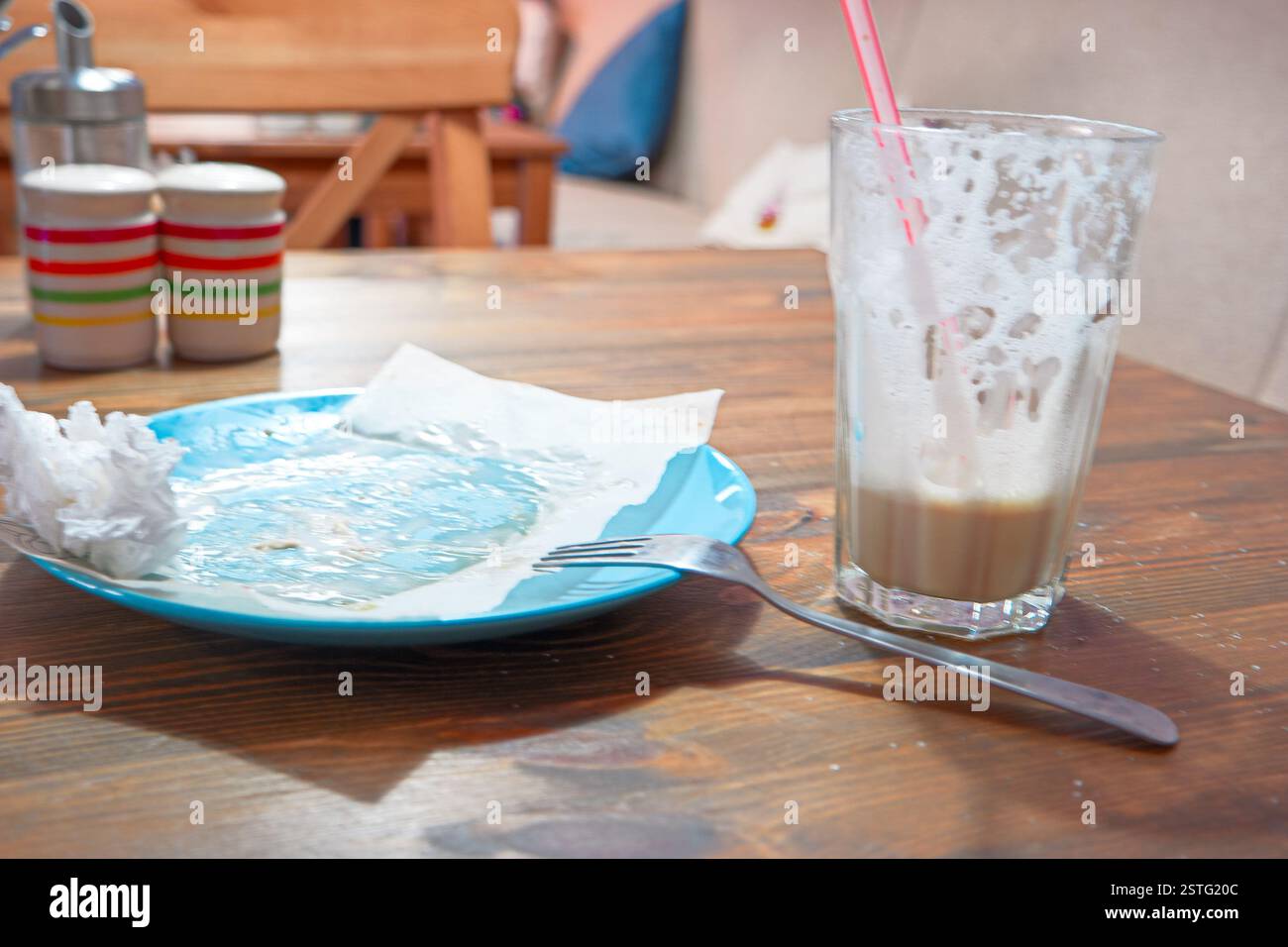 Dirty empty plate and half-empty glass of coffee on the table side view ...
