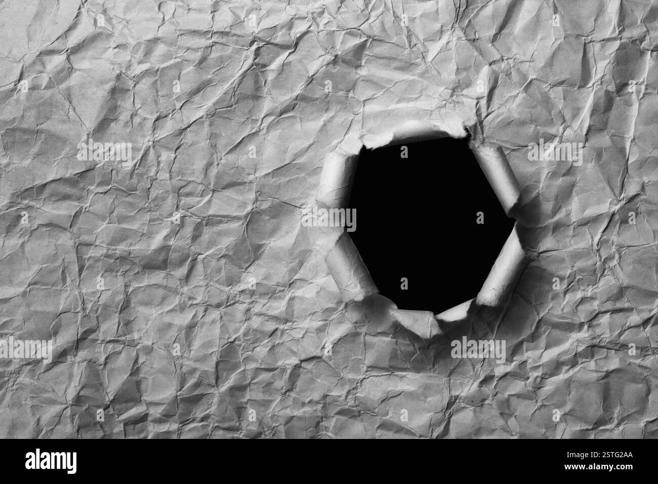 Old gray crumpled paper with a black hole and curled edges Stock Photo ...