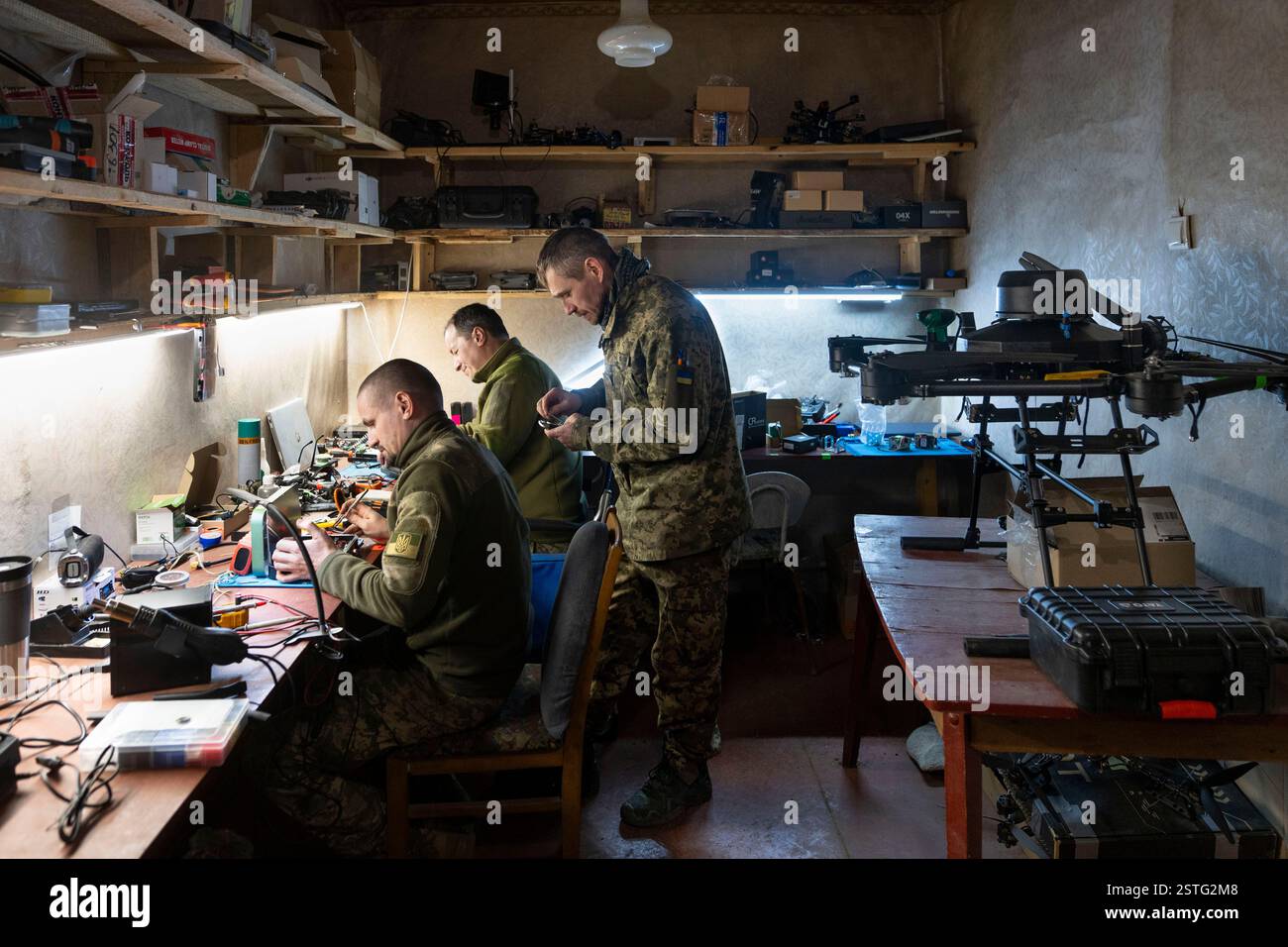 Ukrainian soldiers repair, maintain, and upgrade drones at a workshop. The war between Ukraine ...