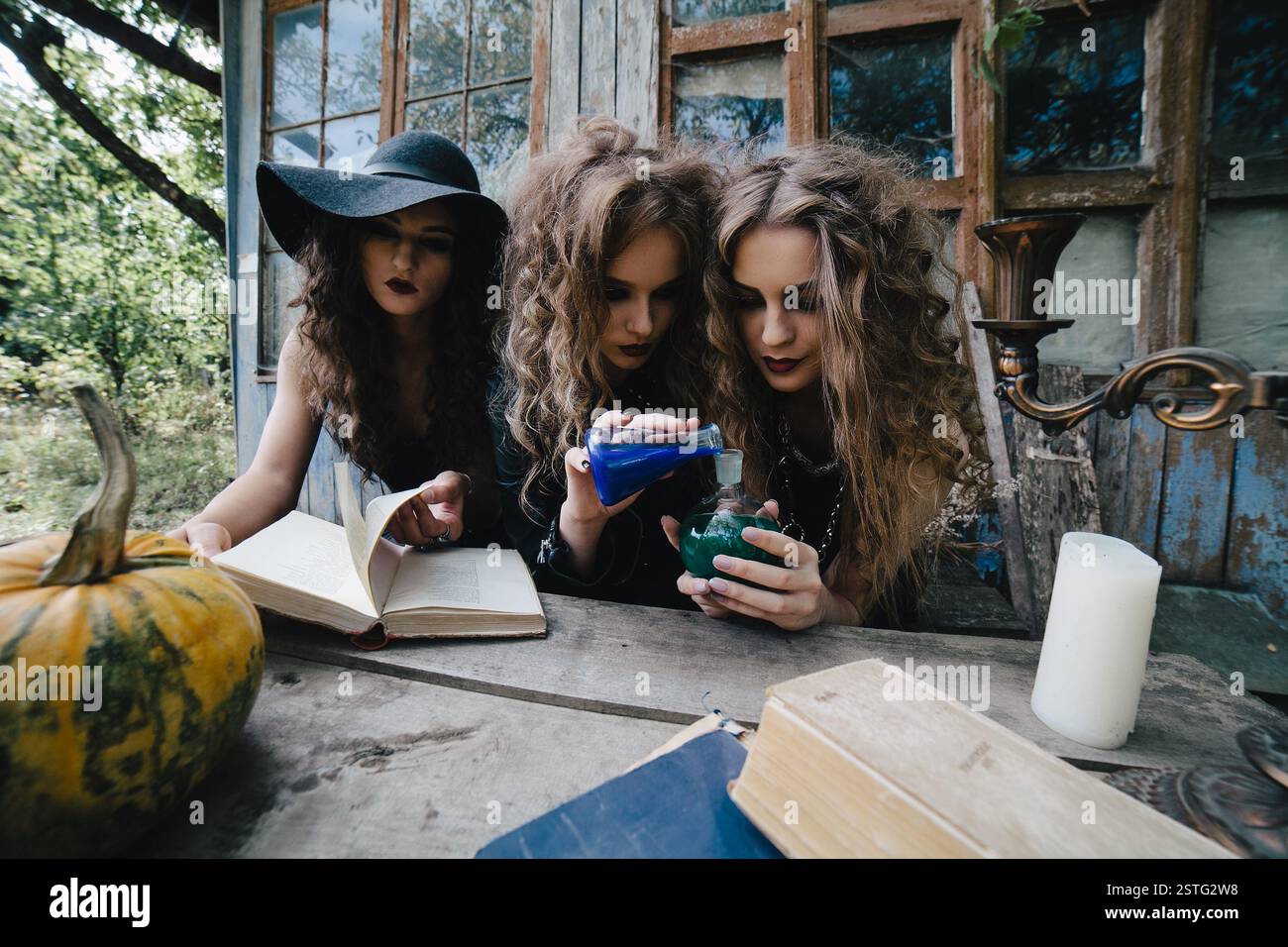 Three vintage witches perform magic ritual Stock Photo - Alamy