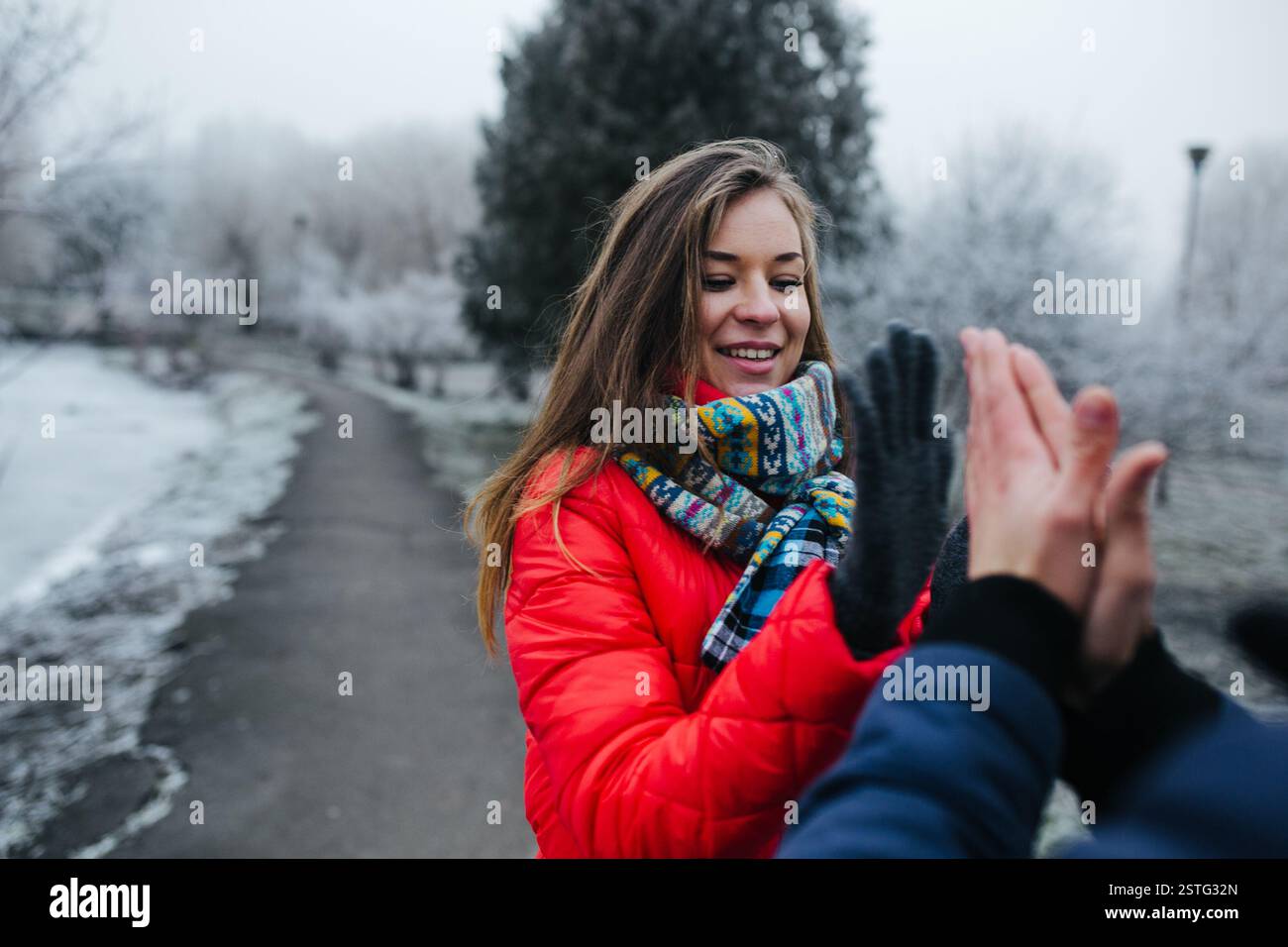 beautiful young couple staning and clapping in the park Stock Photo - Alamy