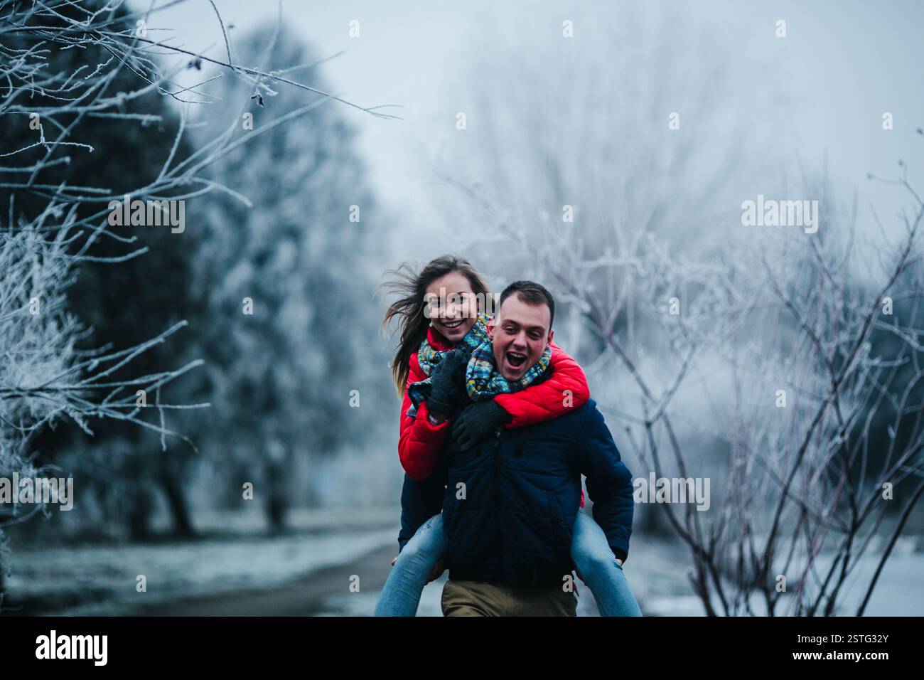 Man carries his girlfriend on back Stock Photo - Alamy