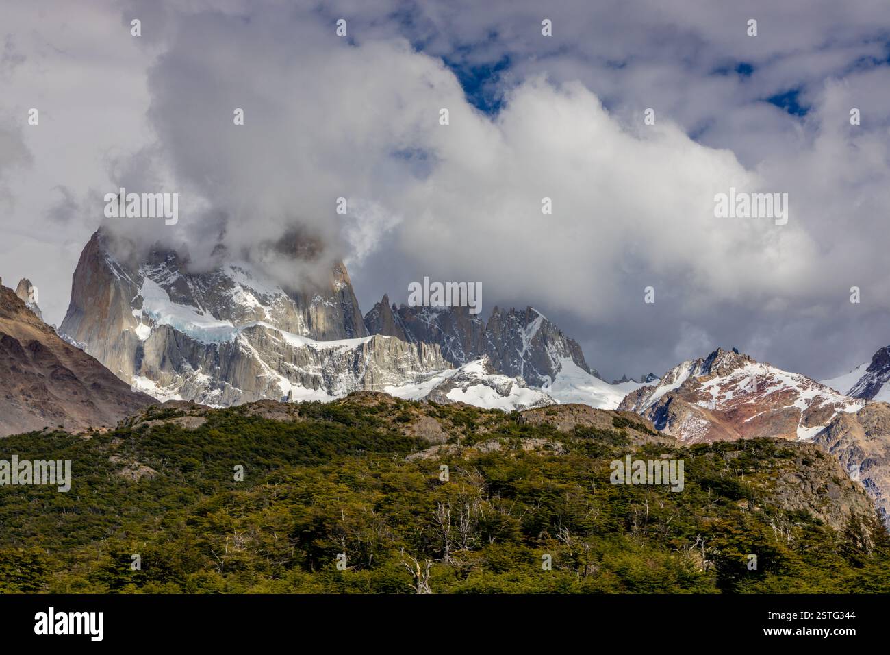 Fitz Roy sharp mountain peaks rise above a serene glacial lake ...