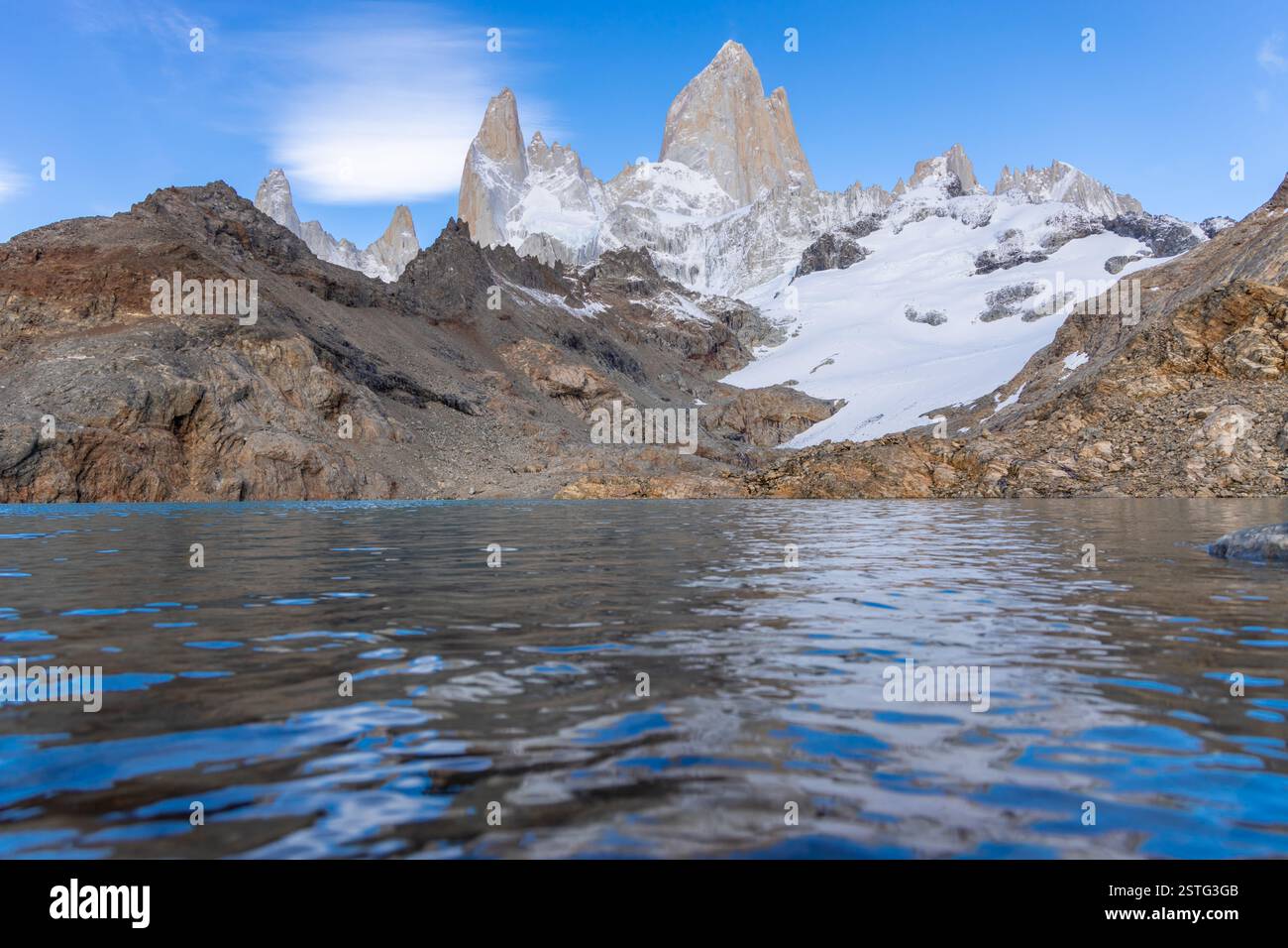 Fitz Roy sharp mountain peaks rise above a serene glacial lake ...