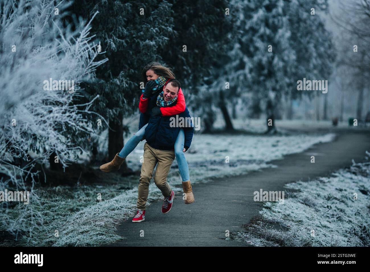 Man carries his girlfriend on back Stock Photo - Alamy