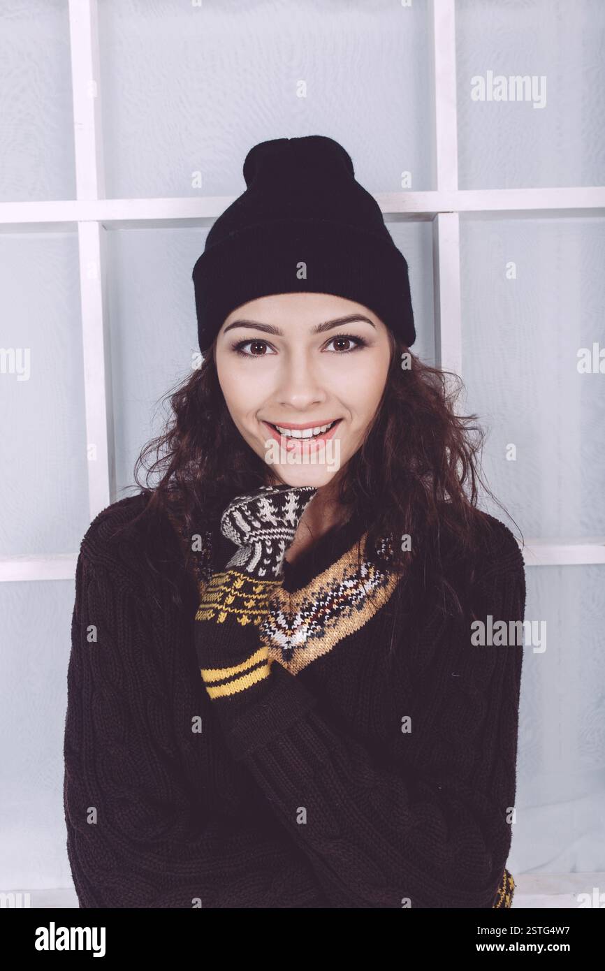 Cute girl in winter outfit posing for the camera Stock Photo - Alamy