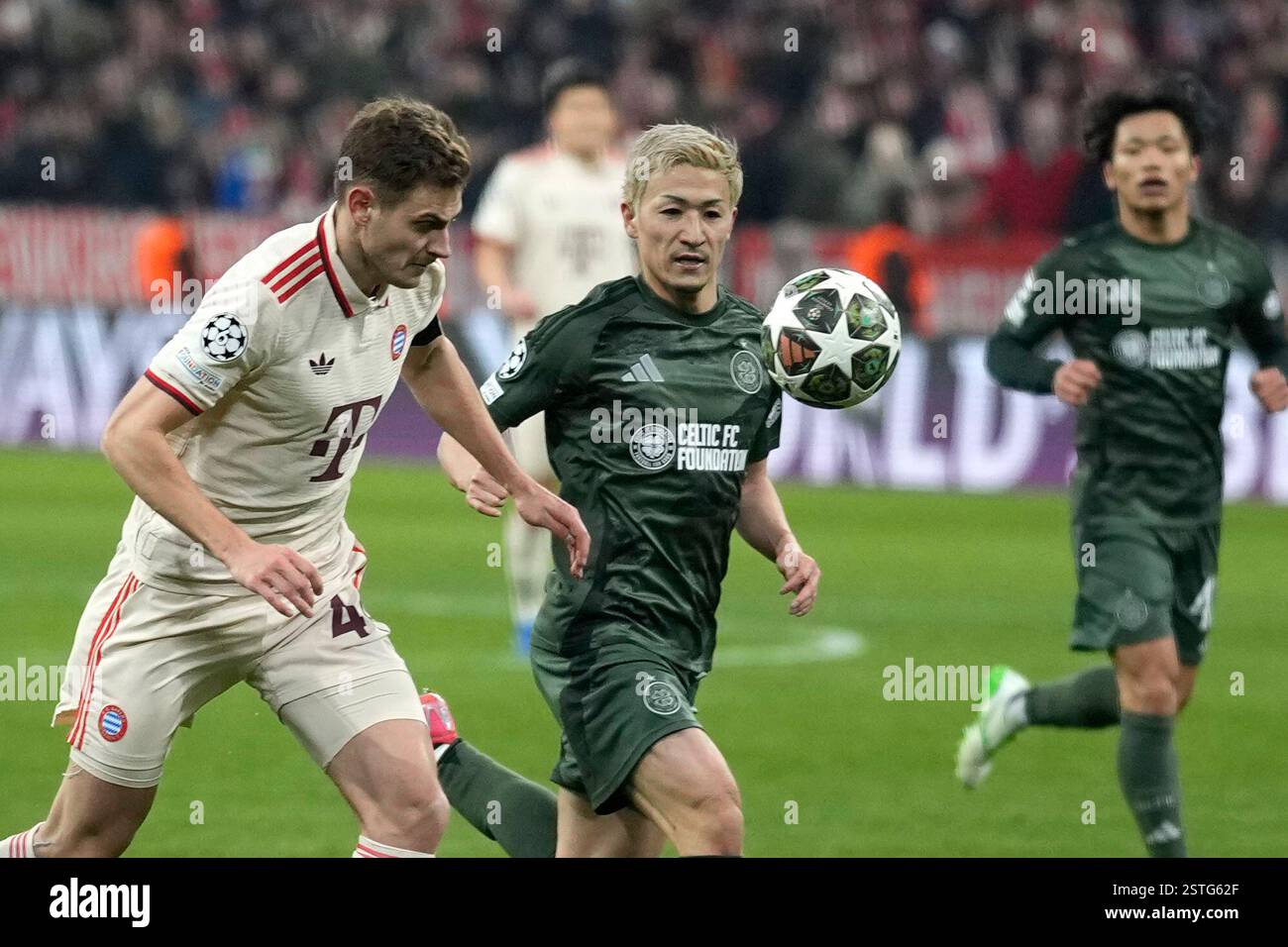 Bayern's Josip Stanisic, left, challenges for the ball with Celtic's ...