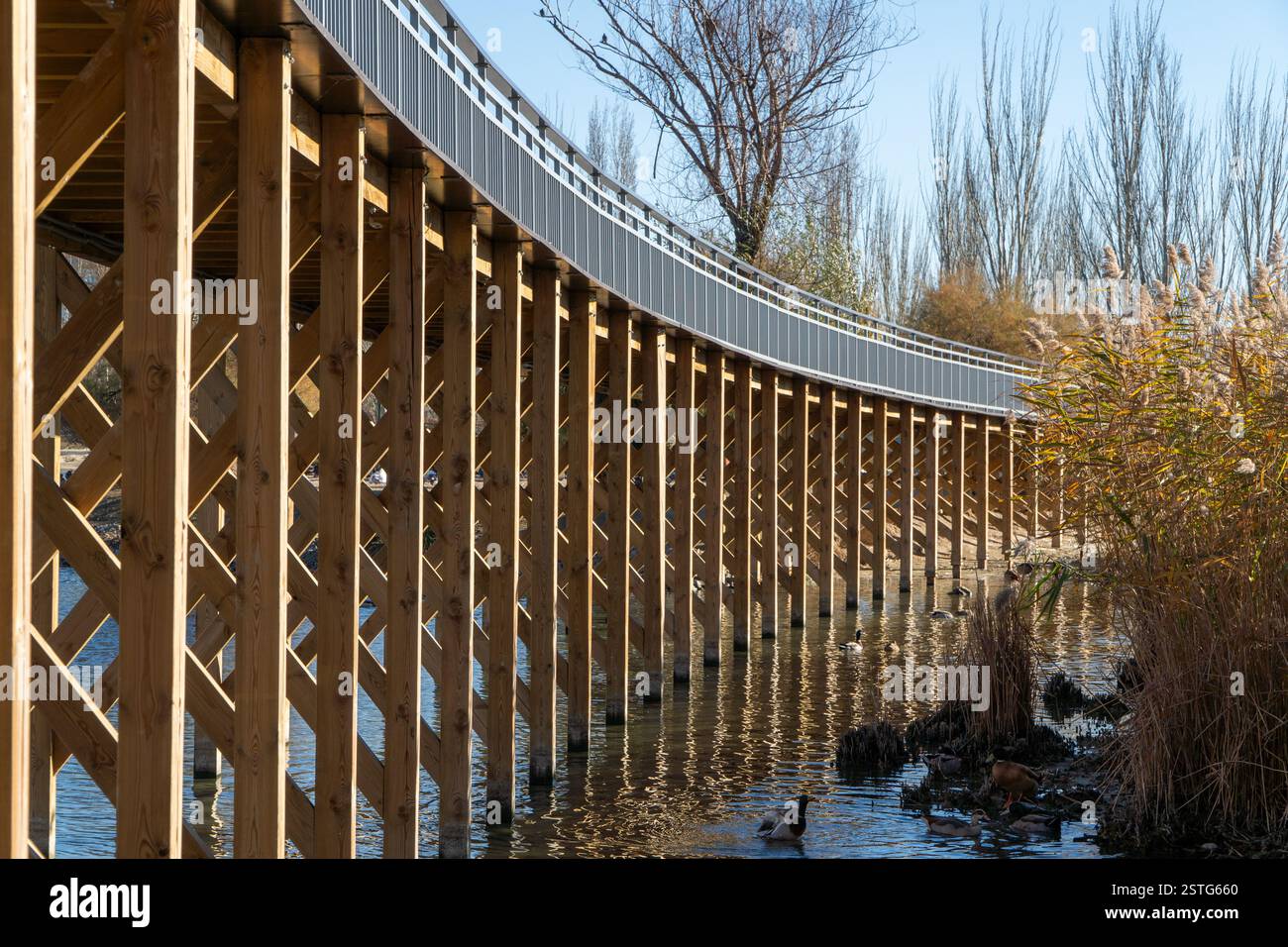 Wooden bridge with sustainable architecture over a lagoon Stock Photo ...