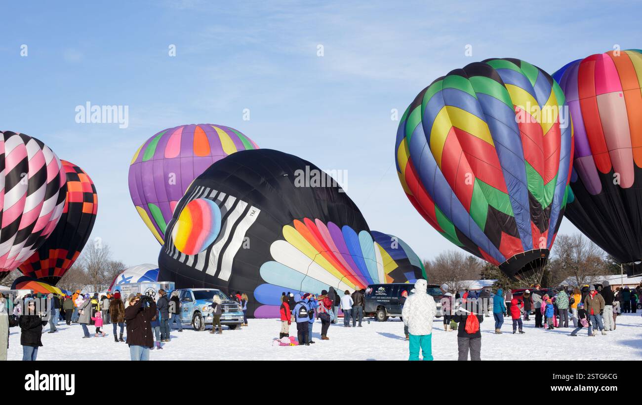 Hot air balloons being inflated at a winter festival during extremely ...