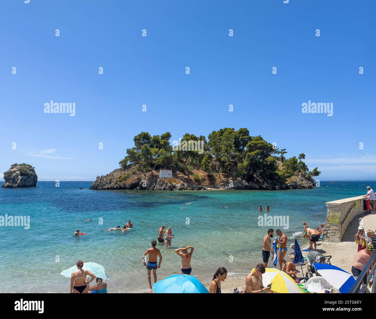Parga, Greece - July 3, 2024: The beach full of people, in and out of ...