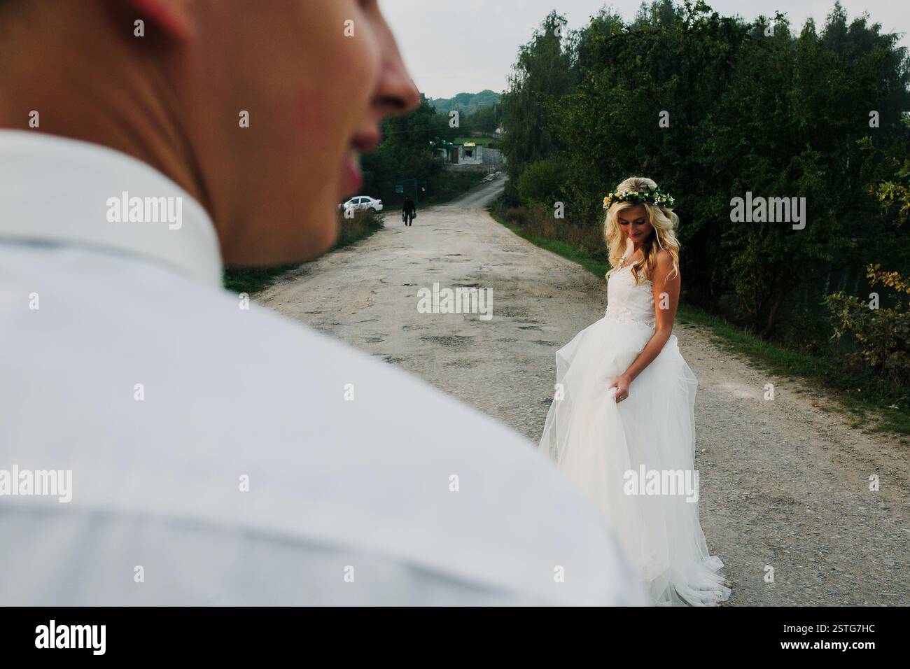 Bride leads groom on the road Stock Photo - Alamy
