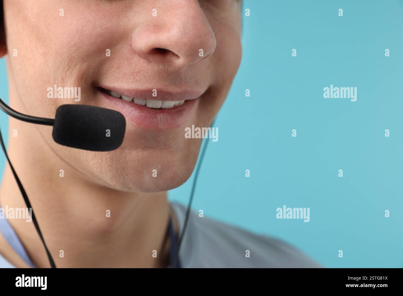 Technical support call center. Smiling operator on light blue ...