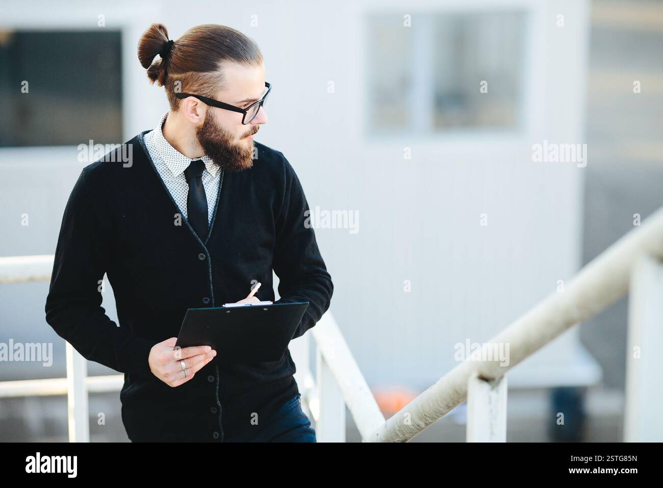 Businessman in black suit stands hi-res stock photography and images ...