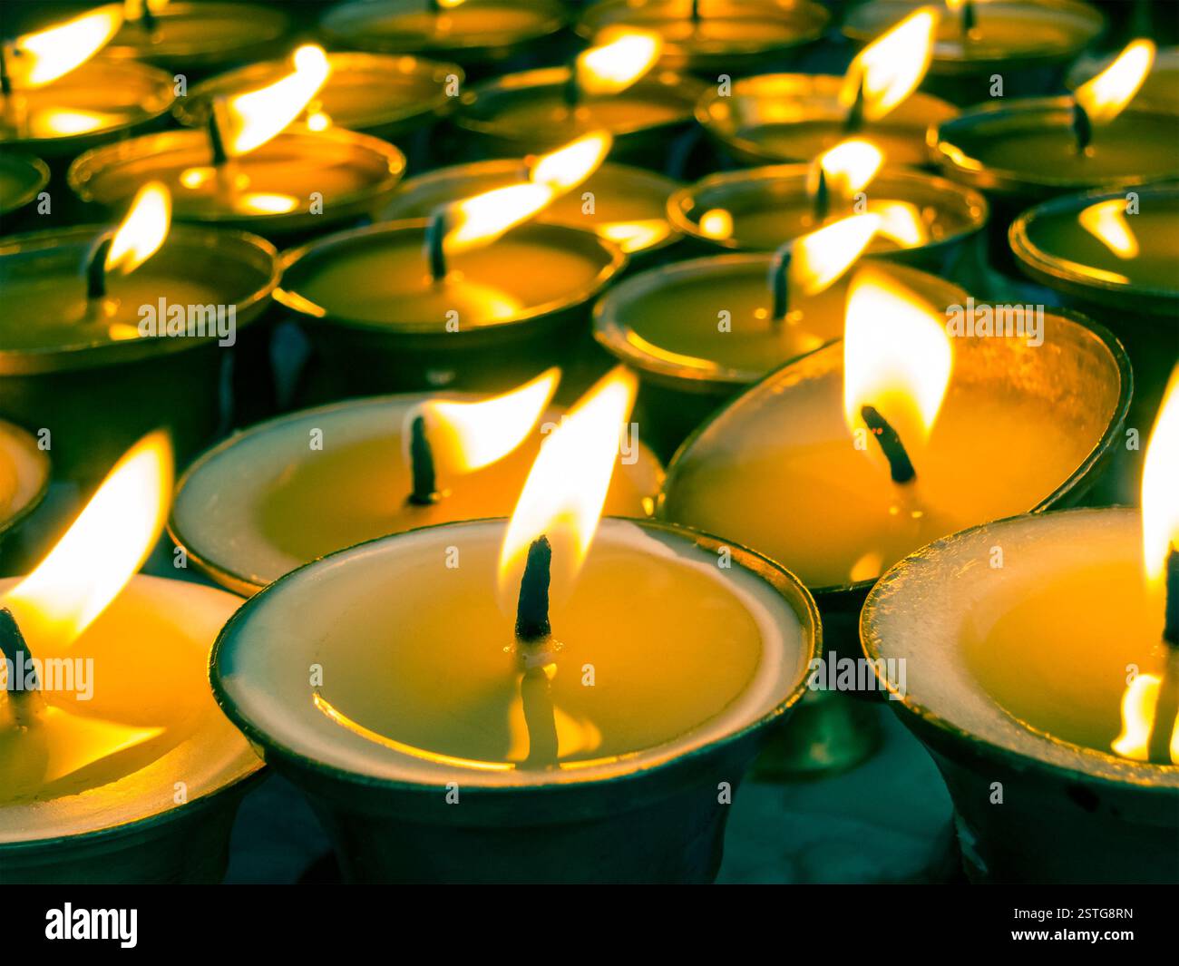 Butter lamps in a buddhist monastery, split tone effect Stock Photo - Alamy