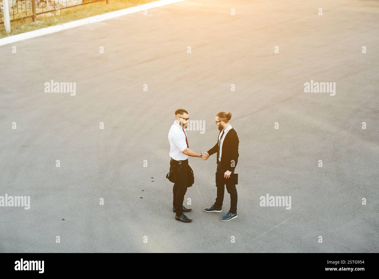 Two businessmen shaking hands Stock Photo - Alamy