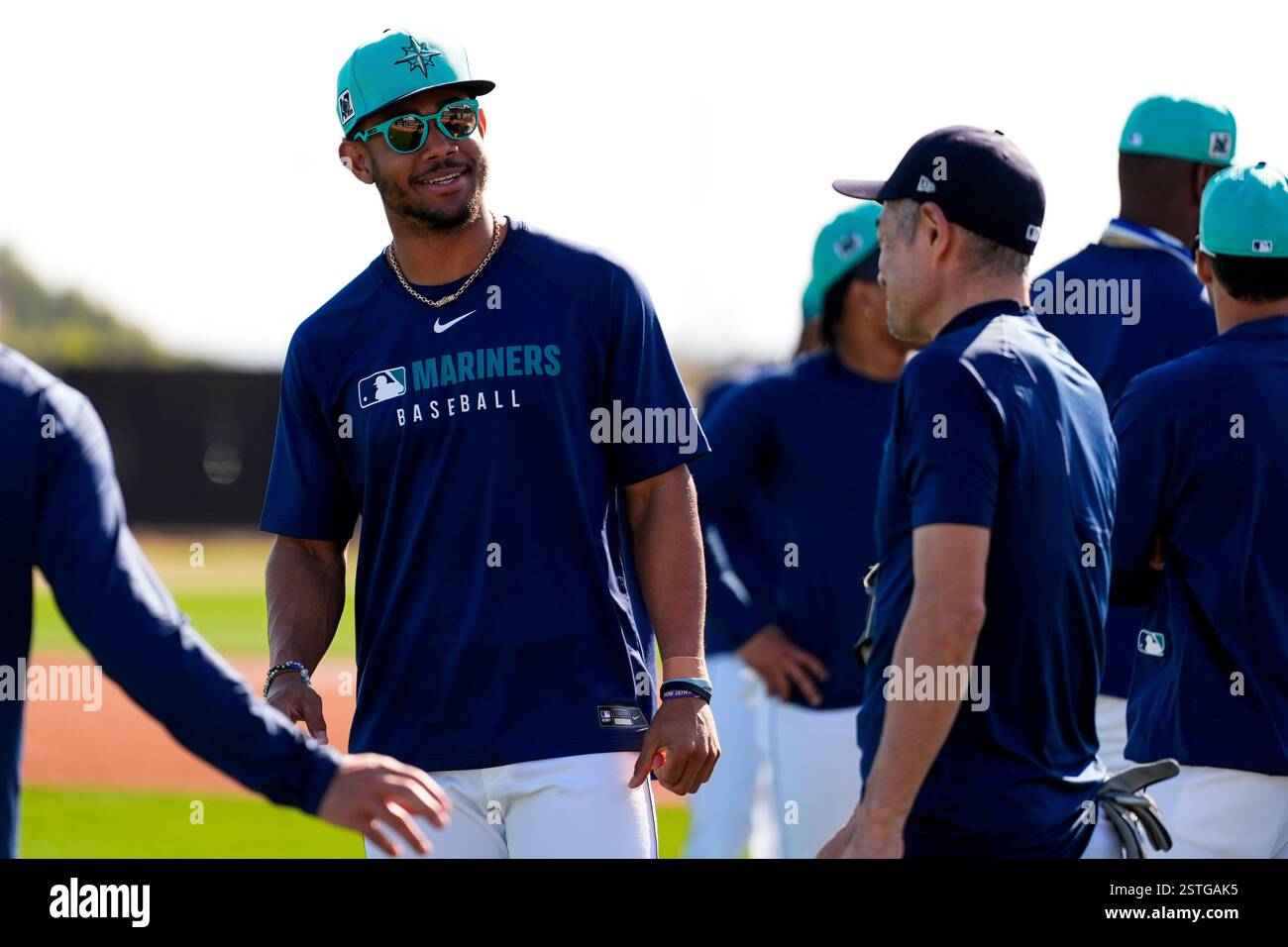 Seattle Mariners center fielder Julio Rodriguez talks with former ...