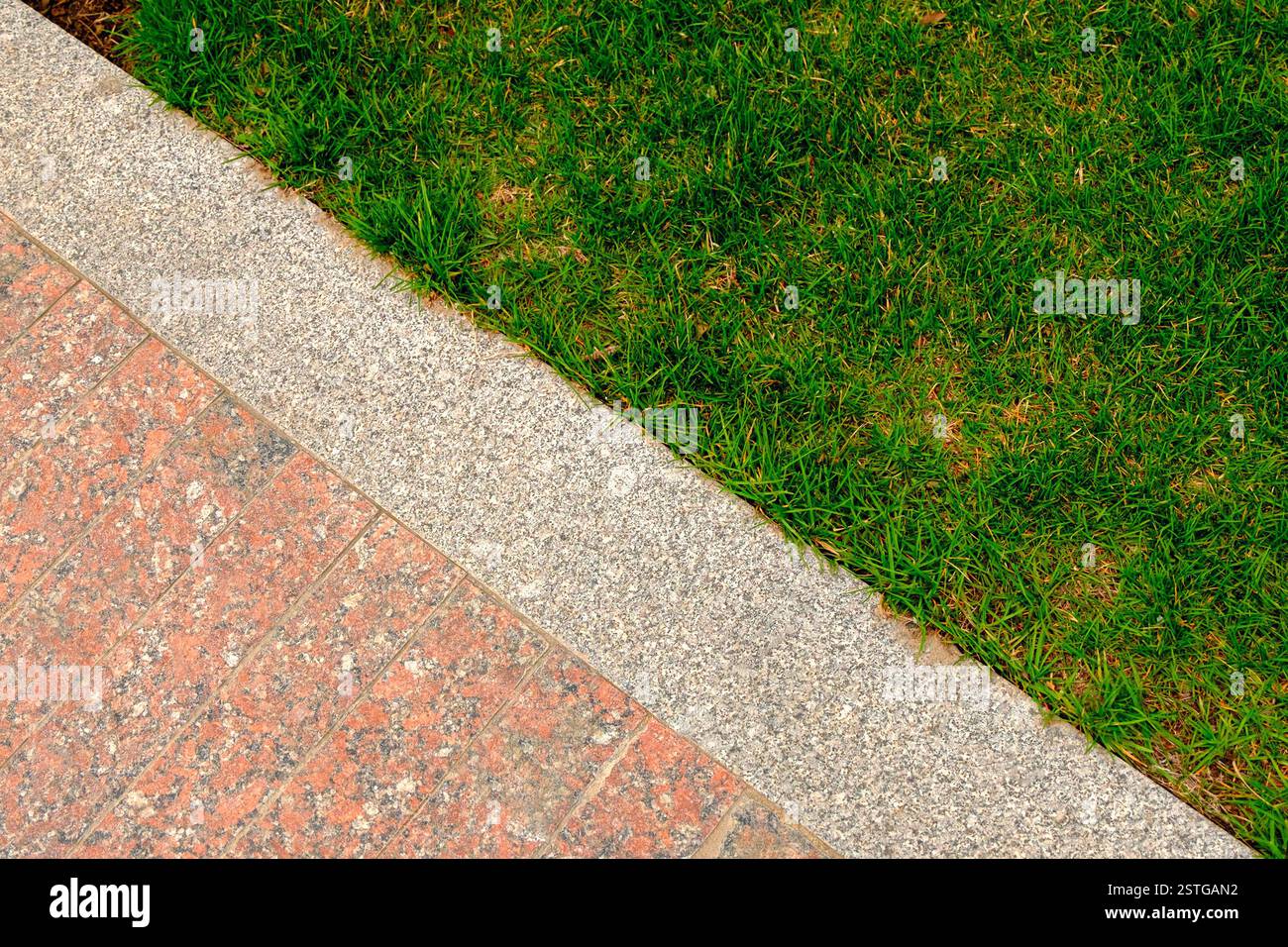 Old granite pavement and grass in garden decorative texture, line ...