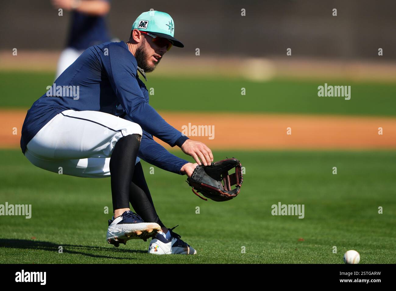 Seattle Mariners' Miles Mastrobuoni fields a ball during spring ...