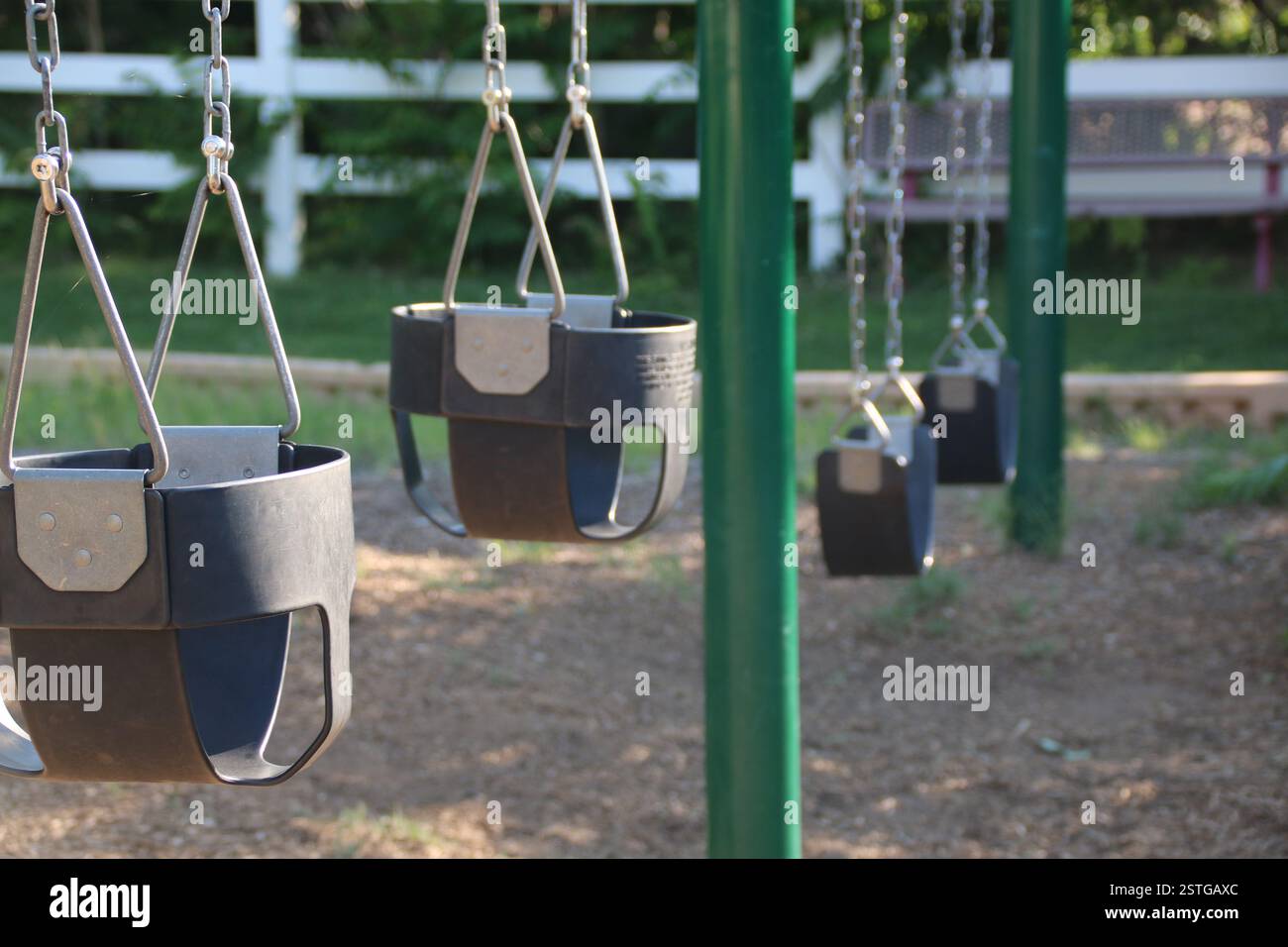 Playground swings with belt seats for older children and bucket seats ...