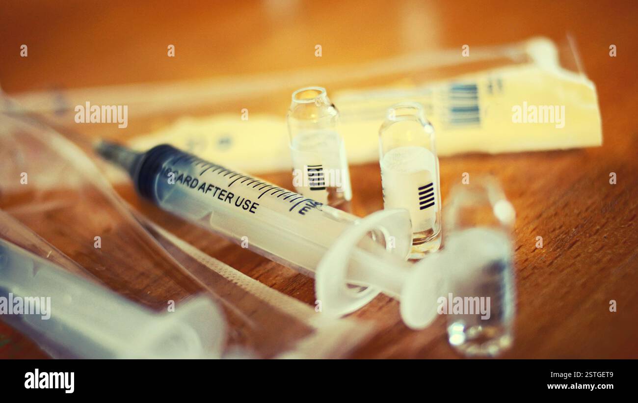 Syringe and empty vials on table macro selective focus shallow dof ...