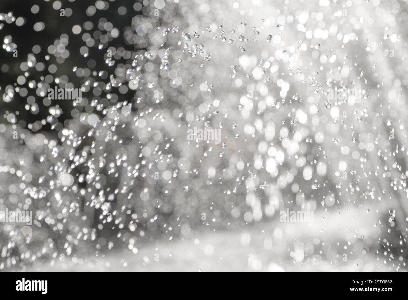 Defocused water drops and blurred spot of light levitating in the air ...