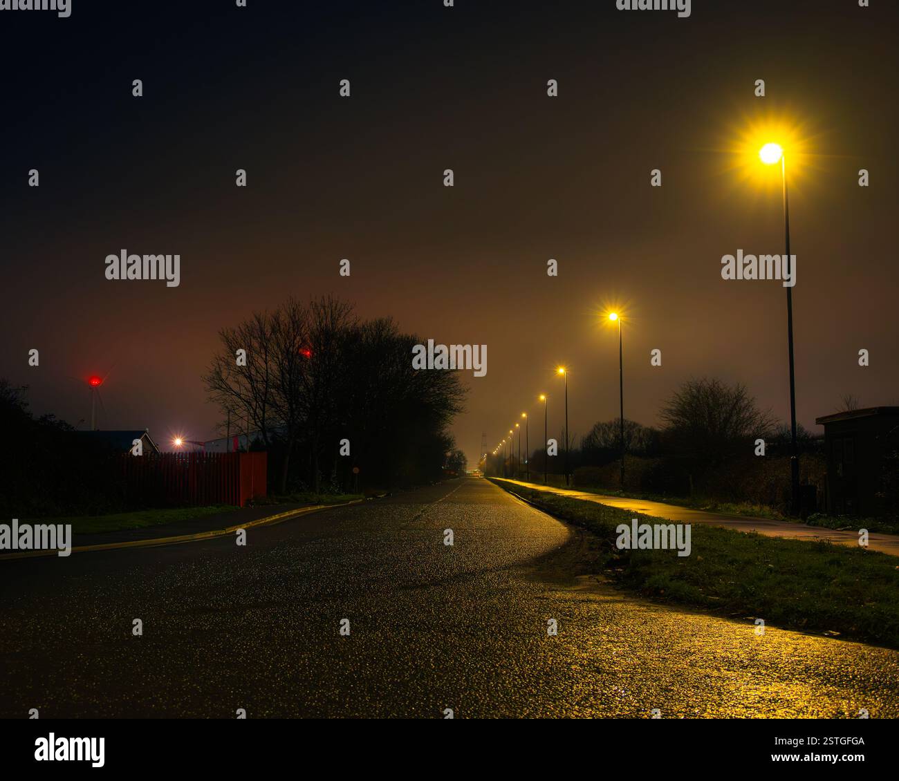 A line of streetlights in an industrial zone late at night Stock Photo ...