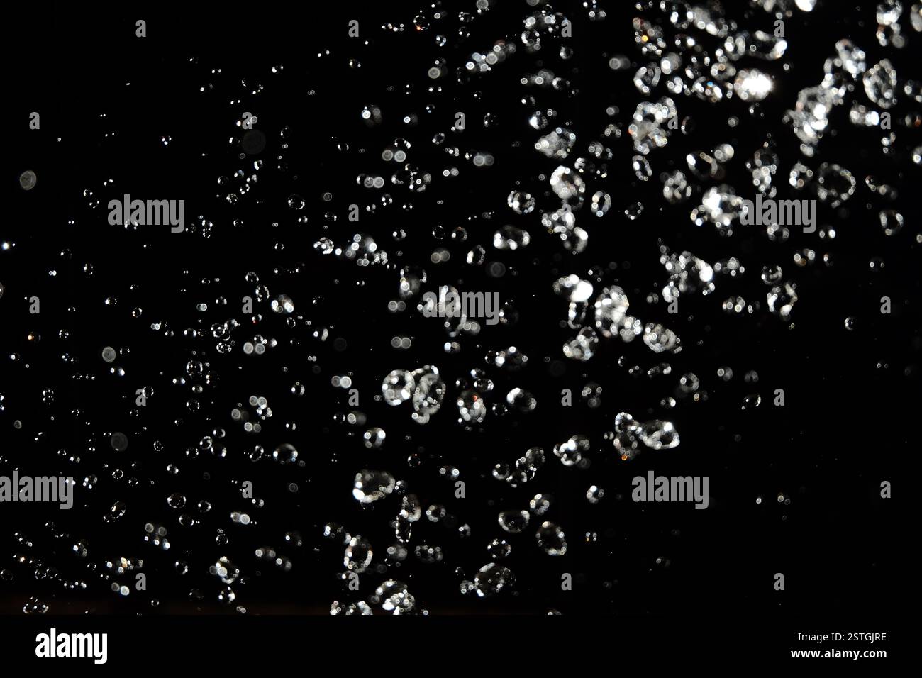 Levitating water background. Water drops fly in the air with defocused ...