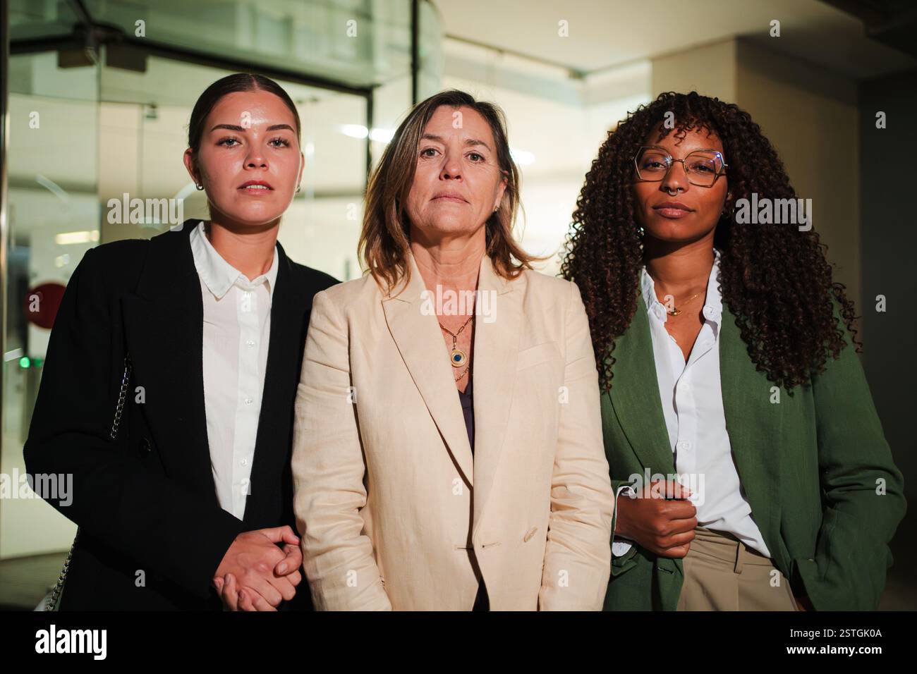 A powerful trio of businesswomen standing together, radiating ...