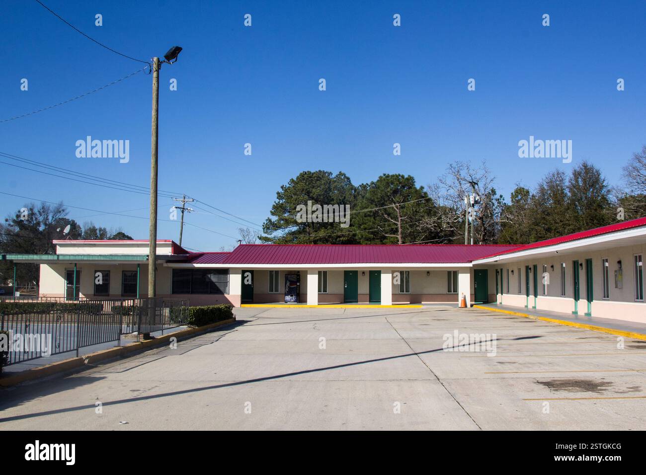 Classic American motel in North Carolina with pink roof and green doors ...