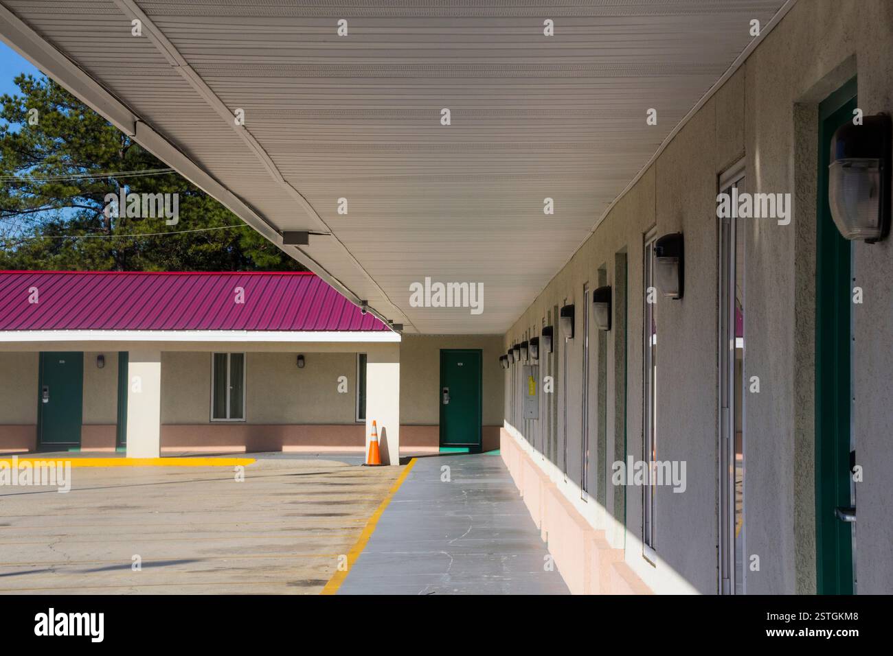 This roadside motel, bathed in the warm glow of the afternoon sun ...