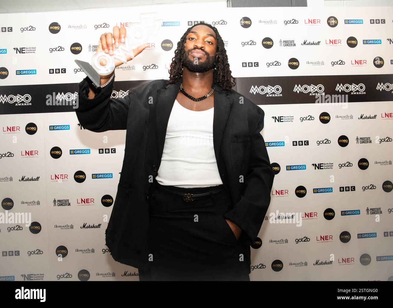 Newcastle, United Kingdom. 18th February 2025. Odeal shows his trophy at the 2025 MOBO Awards ...