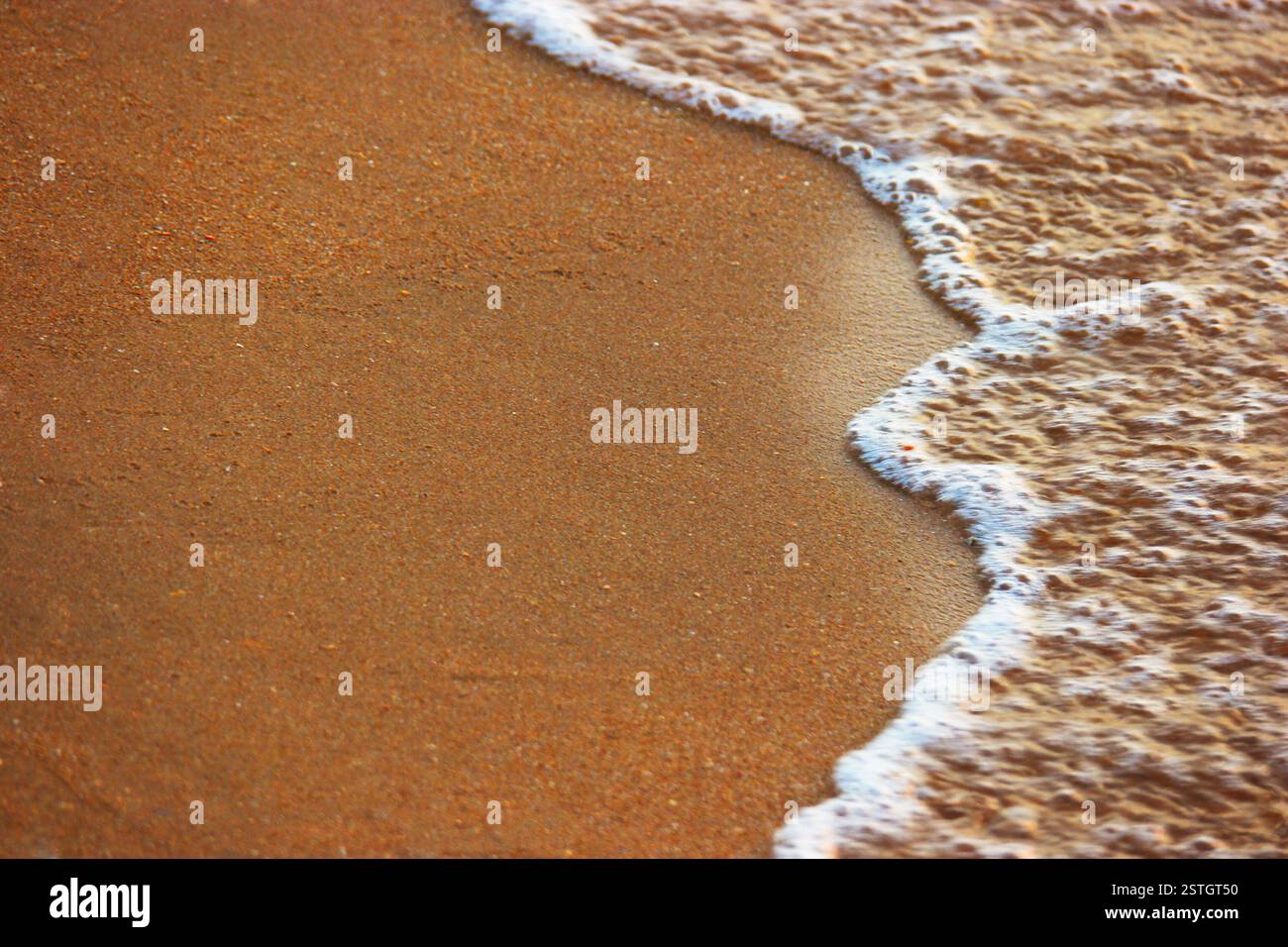 Perfect sand surface and wave of sea covered with foam hi-res stock ...