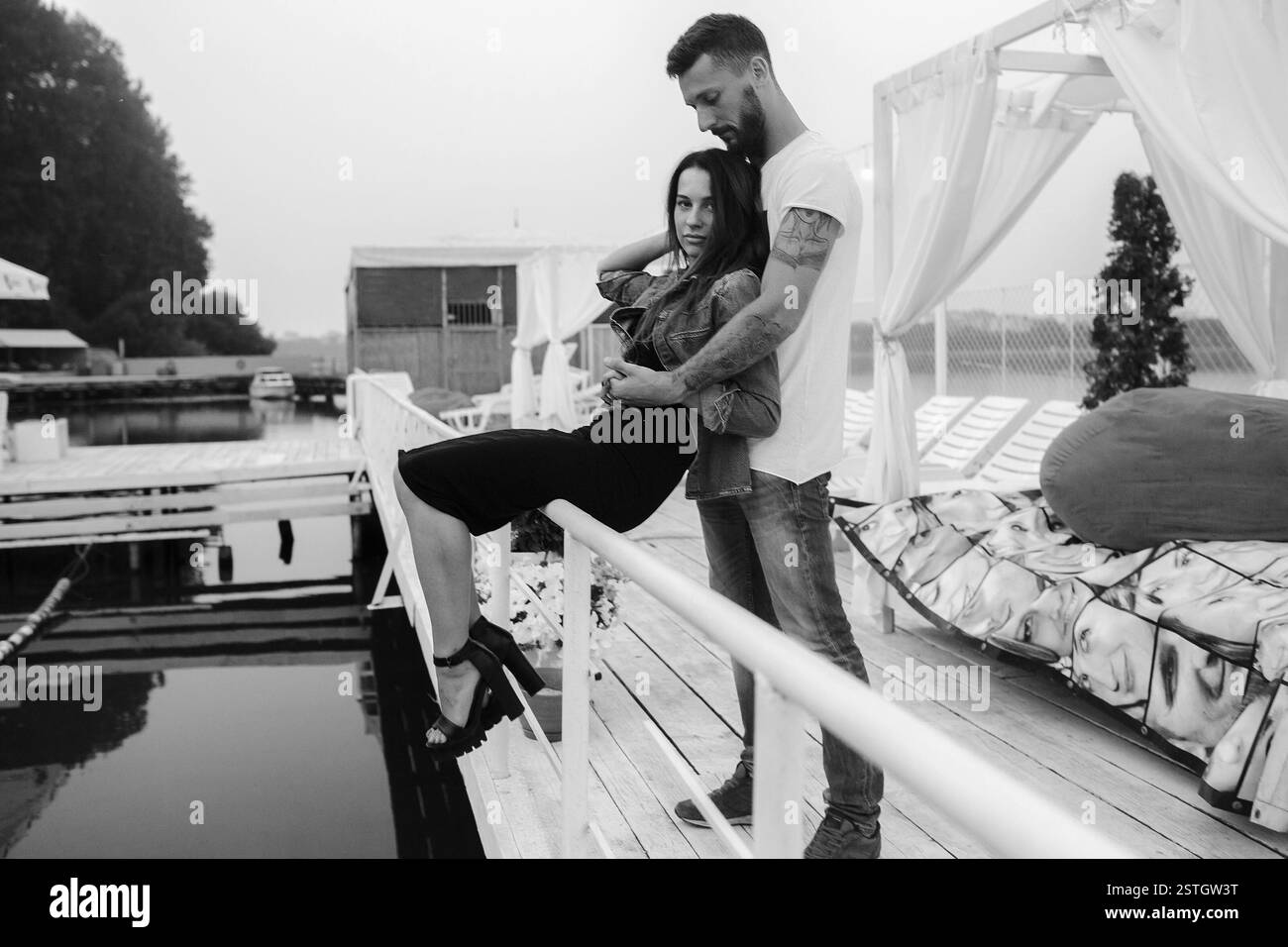 Man hugging woman from behind Stock Photo - Alamy