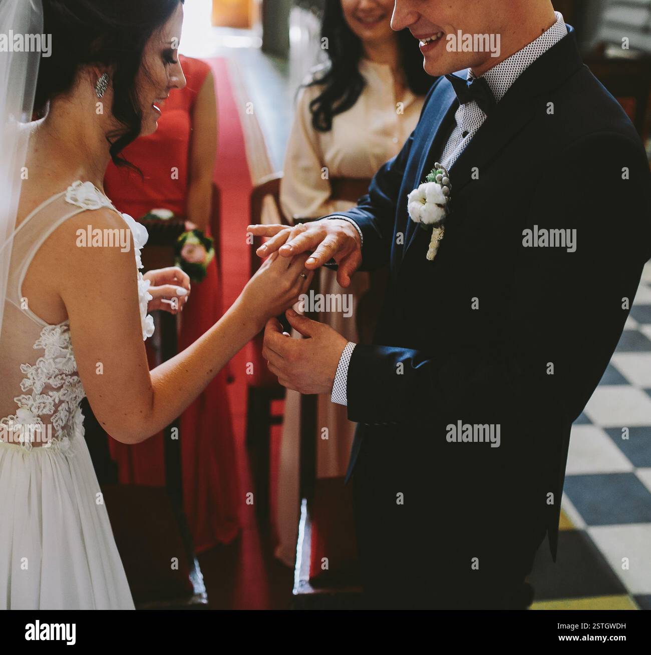 Putting the wedding ring on Stock Photo - Alamy