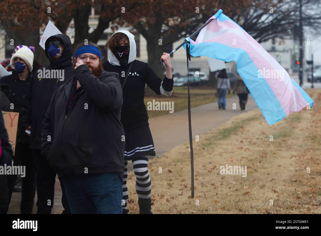 A protester holds a transgender pride flag at a rally outside the ...