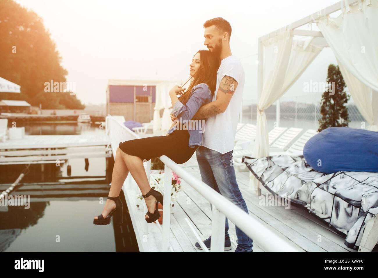 Man hugging woman from behind Stock Photo - Alamy
