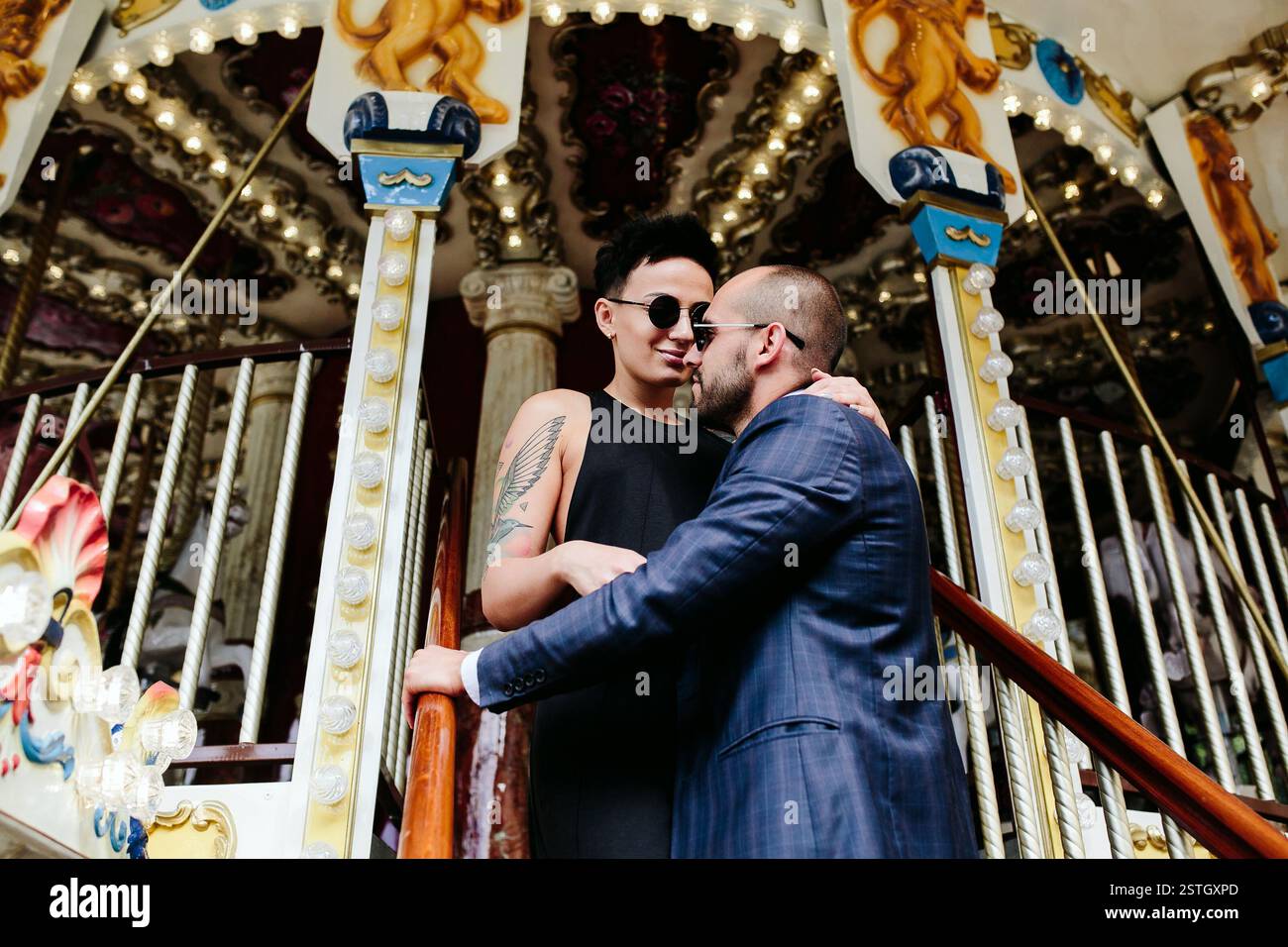 Adult man and woman on a carousel Stock Photo - Alamy