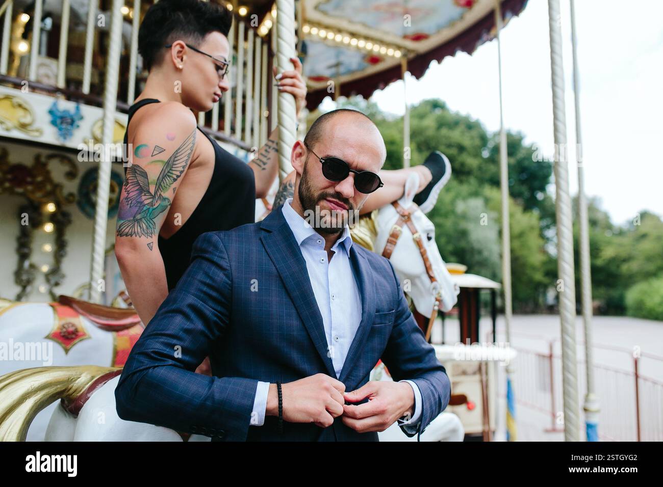 Adult man and woman on merry go round carousel hi-res stock photography ...