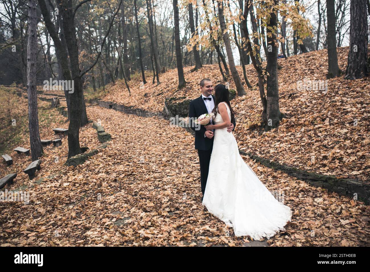 Happy bride and groom posing Stock Photo - Alamy