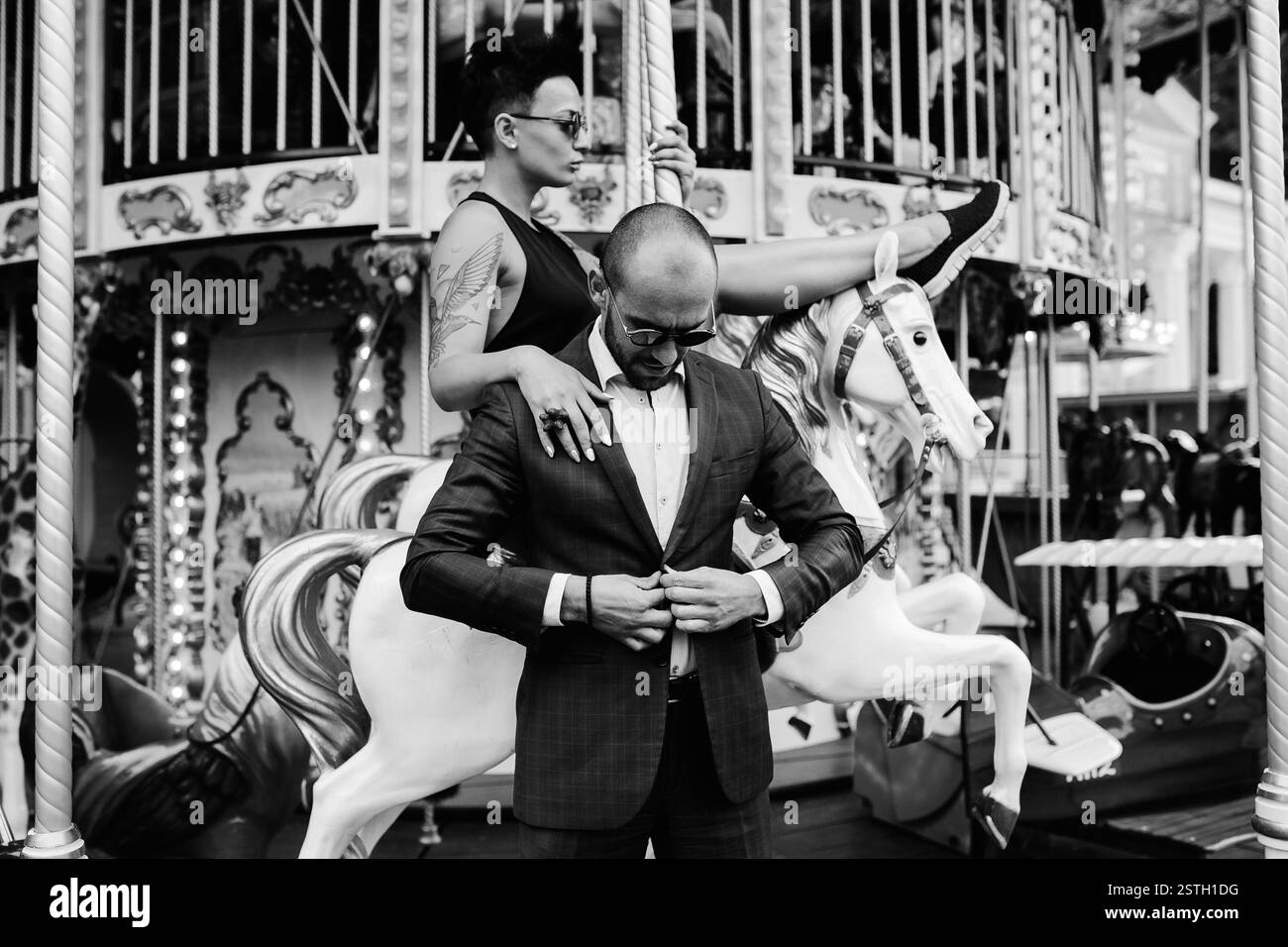 Adult man and woman on a carousel Stock Photo - Alamy