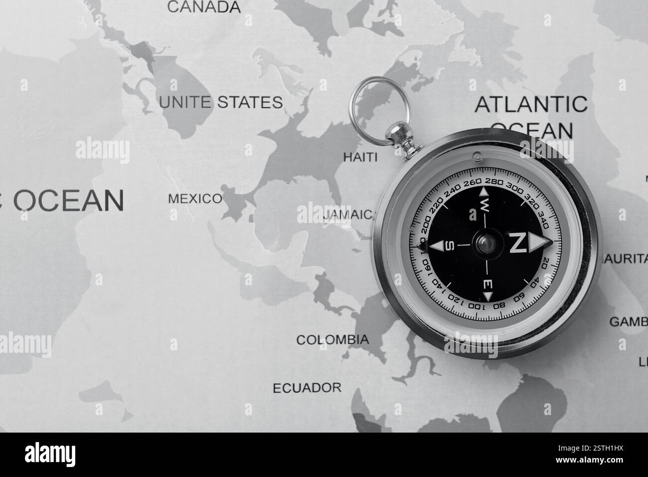 Compass on world map, top view. Toned in black-and-white Stock Photo ...