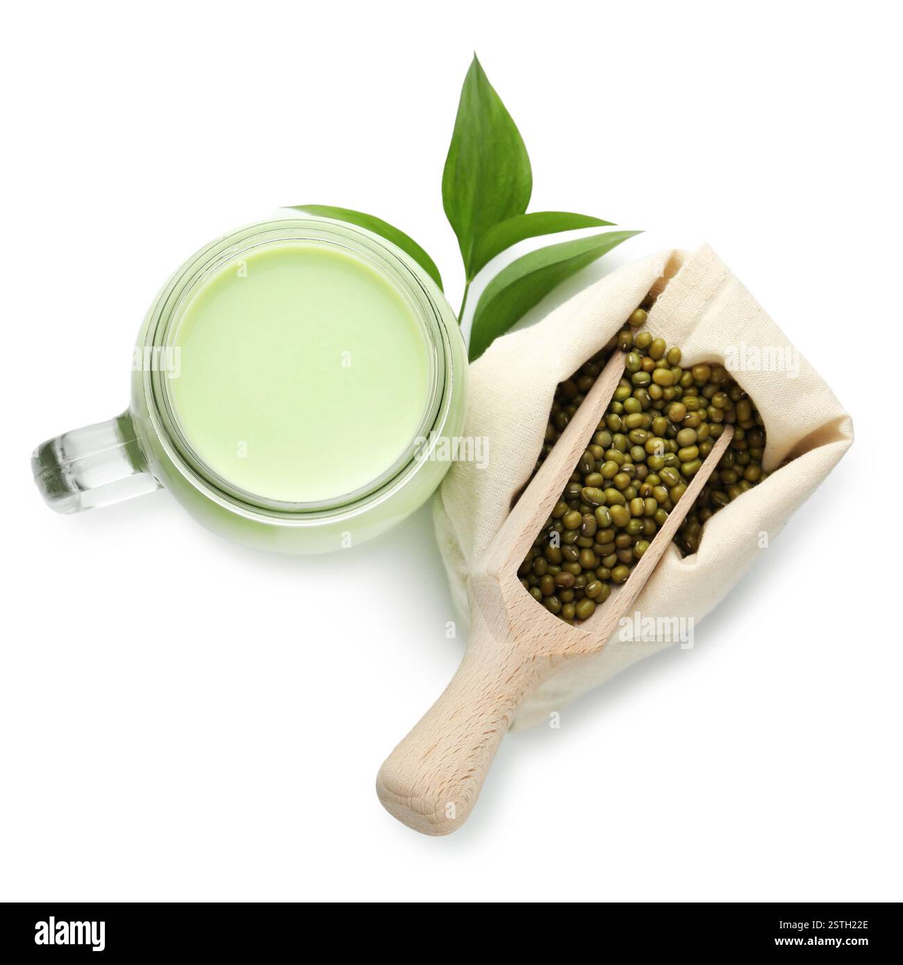 Fresh mung bean juice in mason jar, scoop, seeds and green leaves ...
