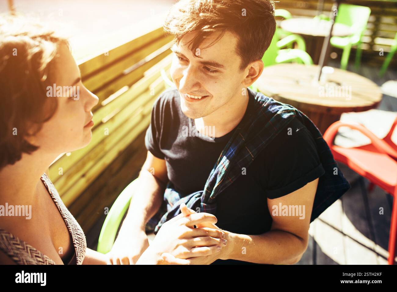Couple sitting outside cafe in hi-res stock photography and images - Alamy