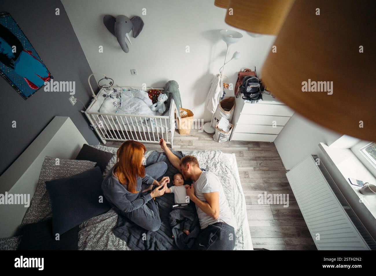 Young parents giving lots of attention to their baby. They are all ...