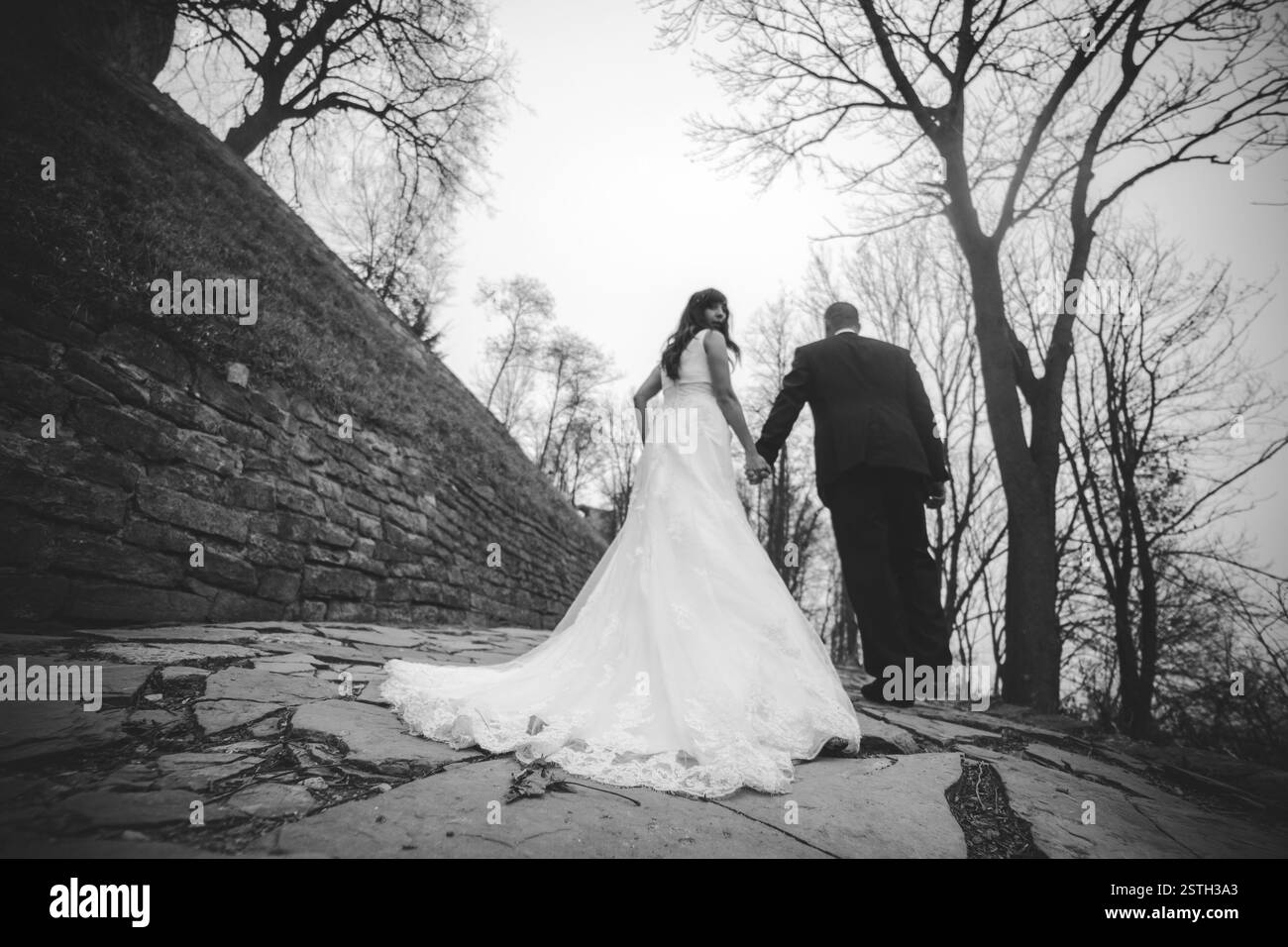 Happy bride and groom walking Stock Photo - Alamy