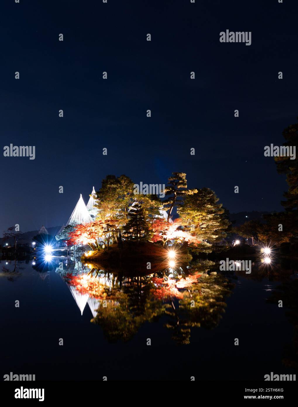 A serene night view of Kenrokuen Garden in Kanazawa, illuminated by ...