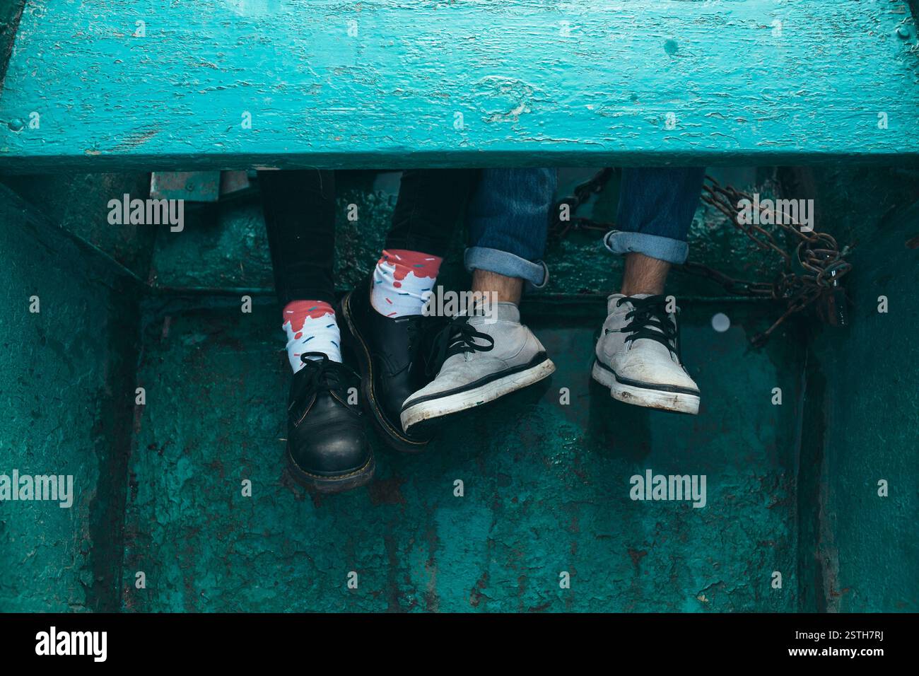 Legs at the shoes in a boat Stock Photo - Alamy