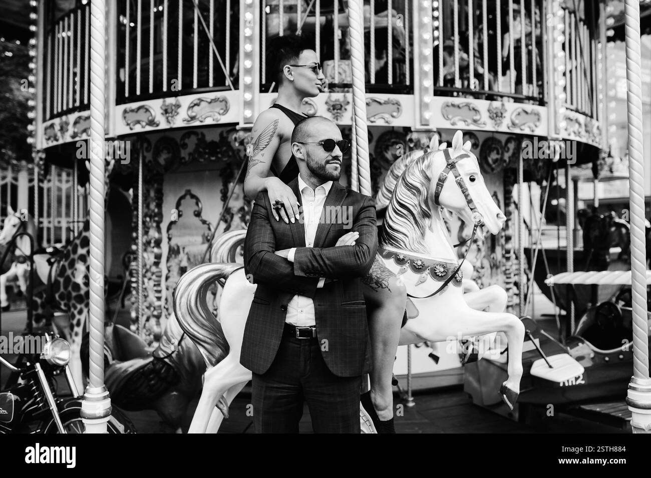 Adult man and woman on a carousel Stock Photo - Alamy