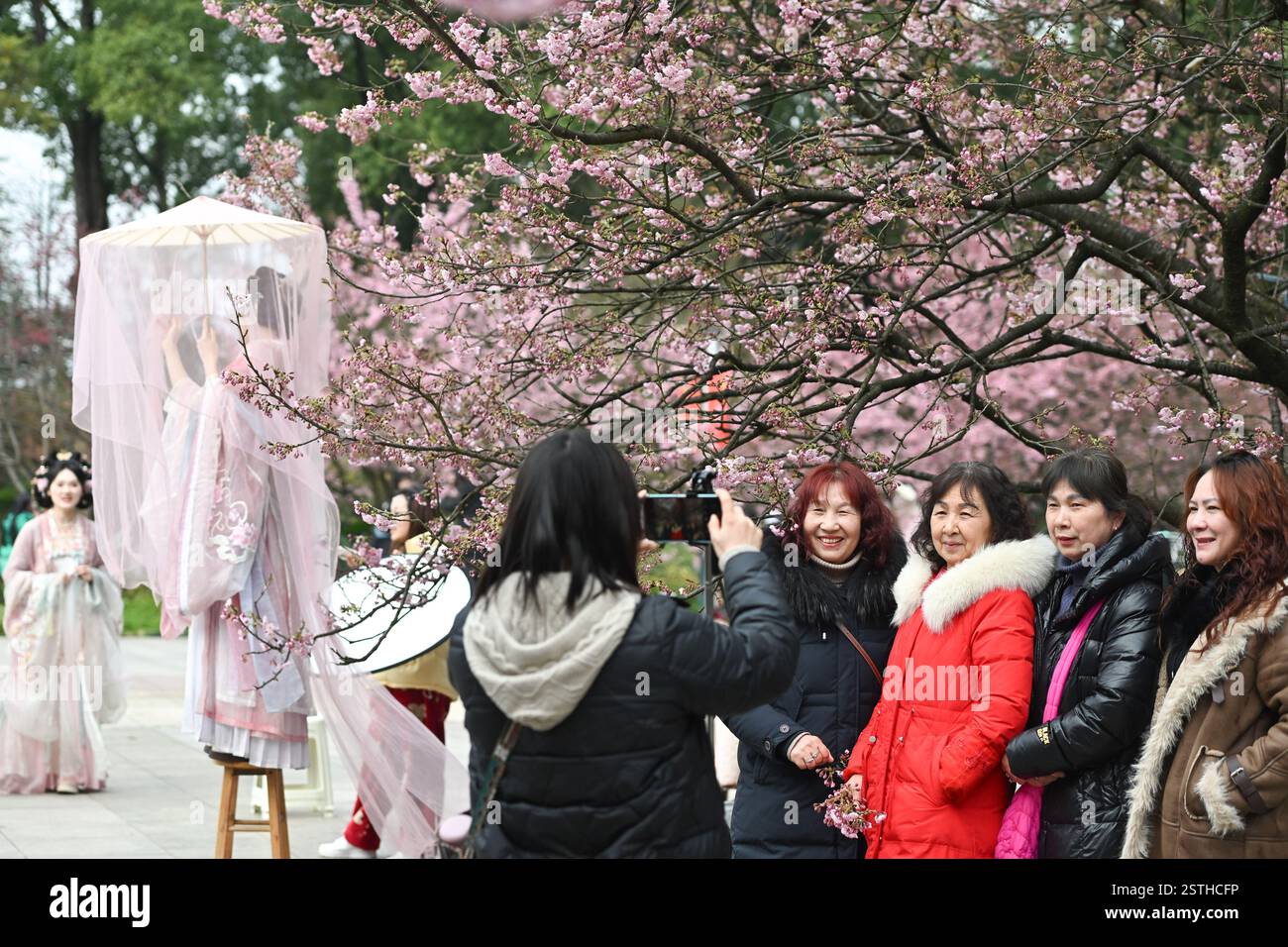 Chongqing,China.18th February 2025. Visitors pose for photos with ...