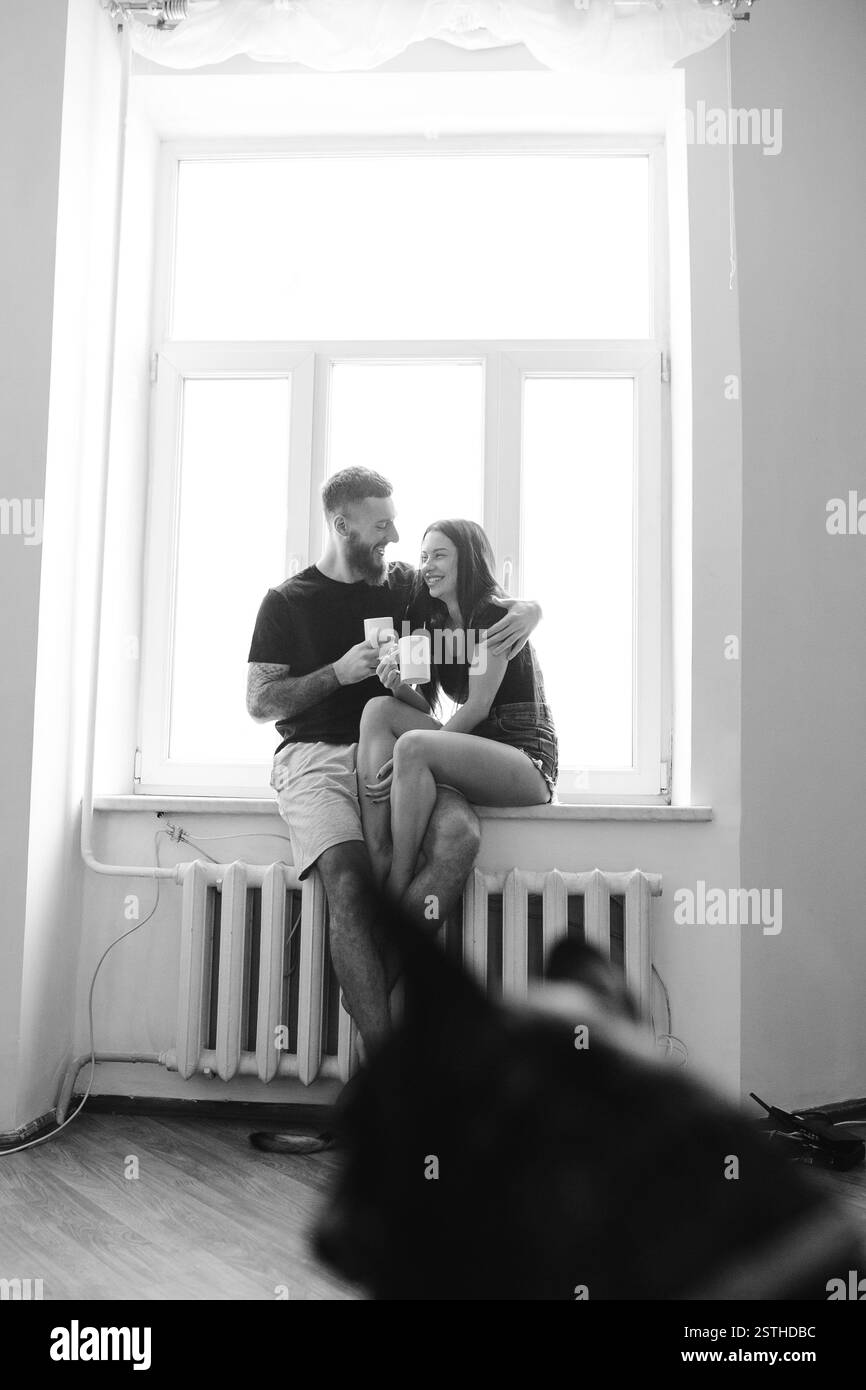 Happy young couple window Black and White Stock Photos & Images - Alamy